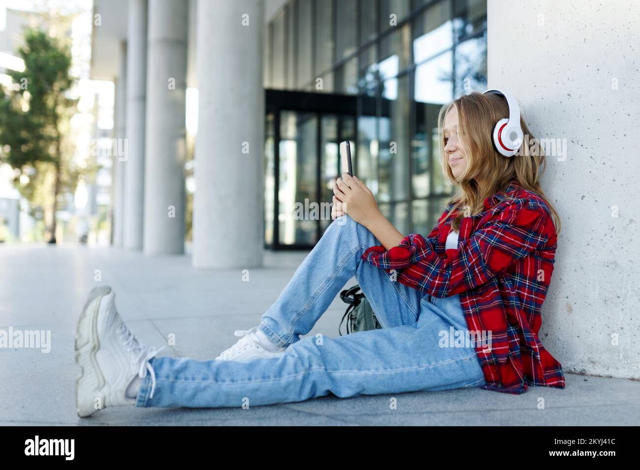 Young smiling beautiful hipster happy teen girl in city street,speaking ...