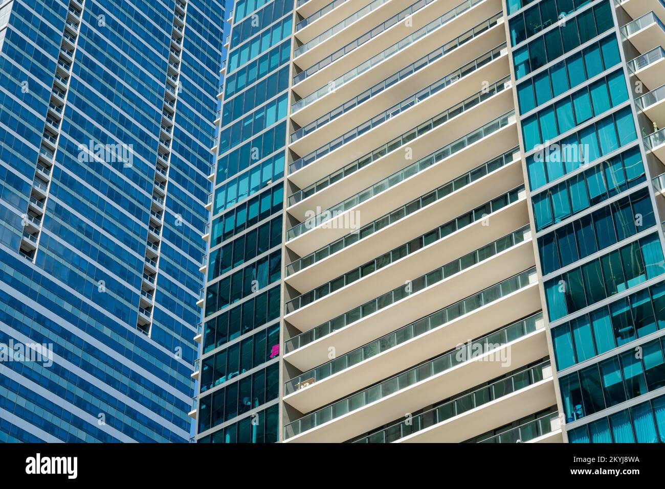 Low angle view of two condominium buildings with glass exterior at ...
