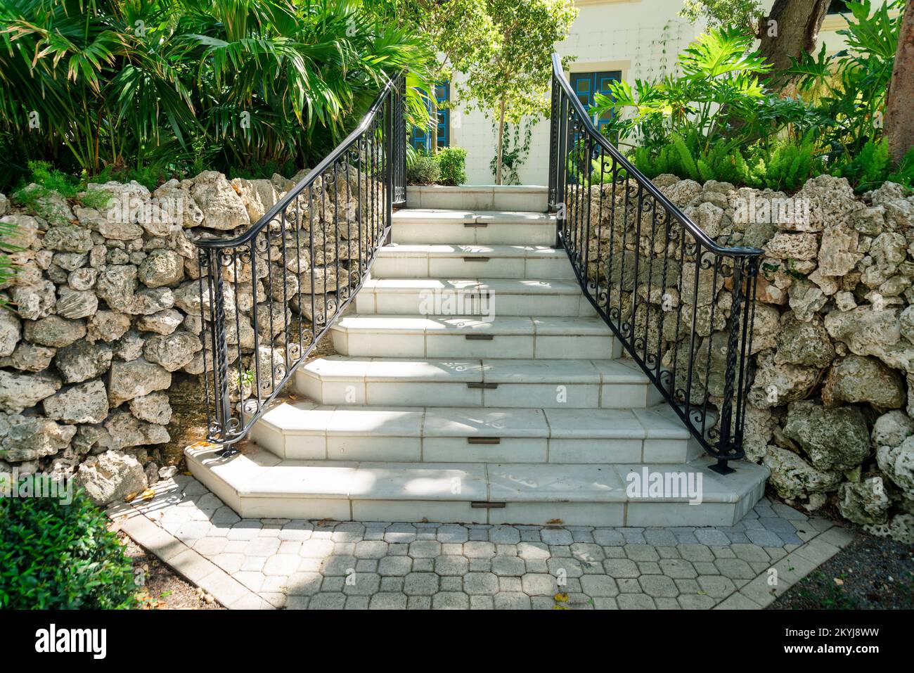 Outdoor stairs with floor-mounted handrails near the stone walls at ...