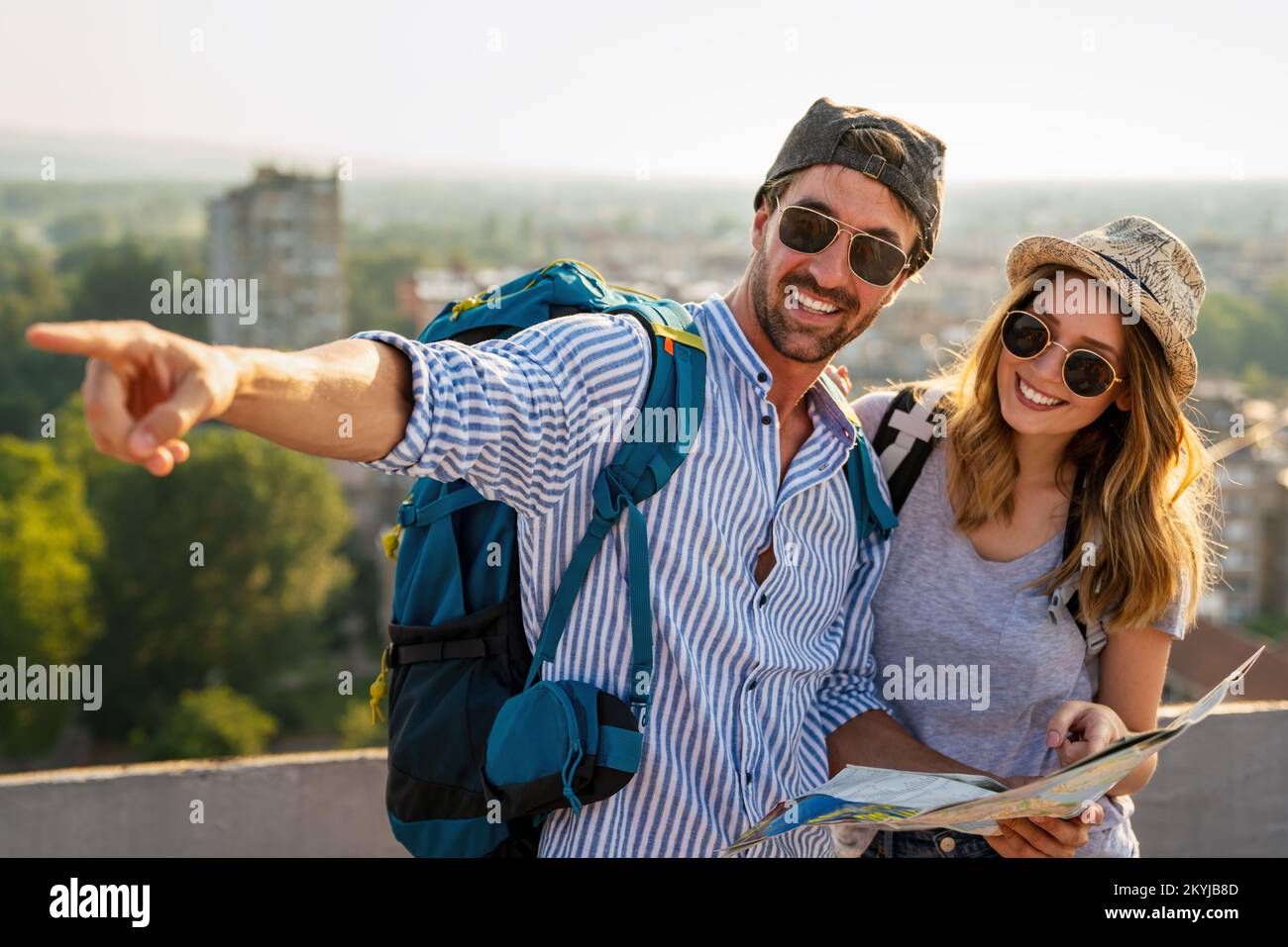 Happy couple on vacation sightseeing city with map. People travel fun ...