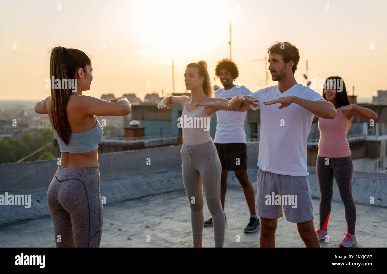Group of fit healthy friends, people exercising together outdoor Stock ...