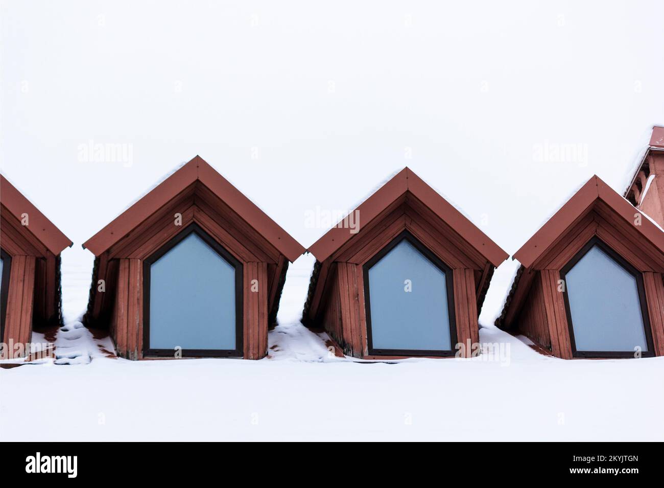 Inclined roof with decorative windows in the snow of an apartment ...