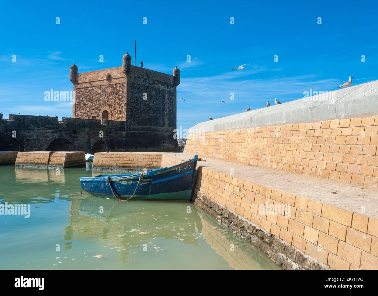 Fortress wall and tower with fishing boat Essaouira, Morocco Stock ...