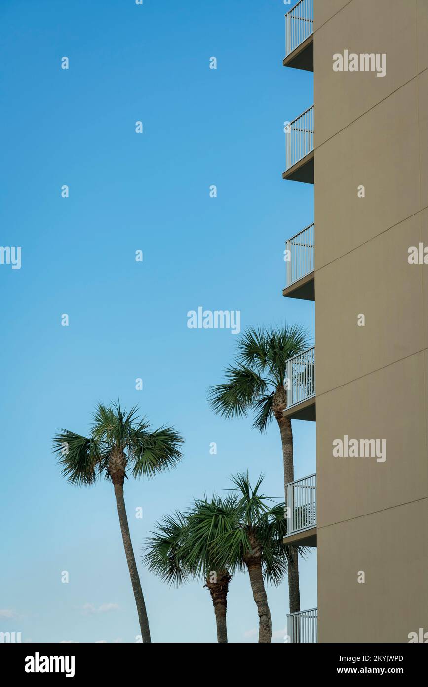 Side of a building with white railings at the balconies with a view of ...
