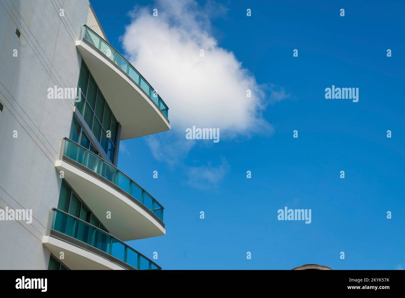 View of triangular balconies with glass railings from below at Miami ...