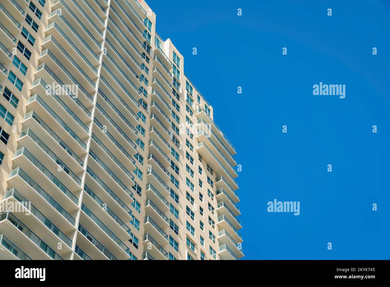 Modern multi-storey condominium with glass railings at the balconies in ...