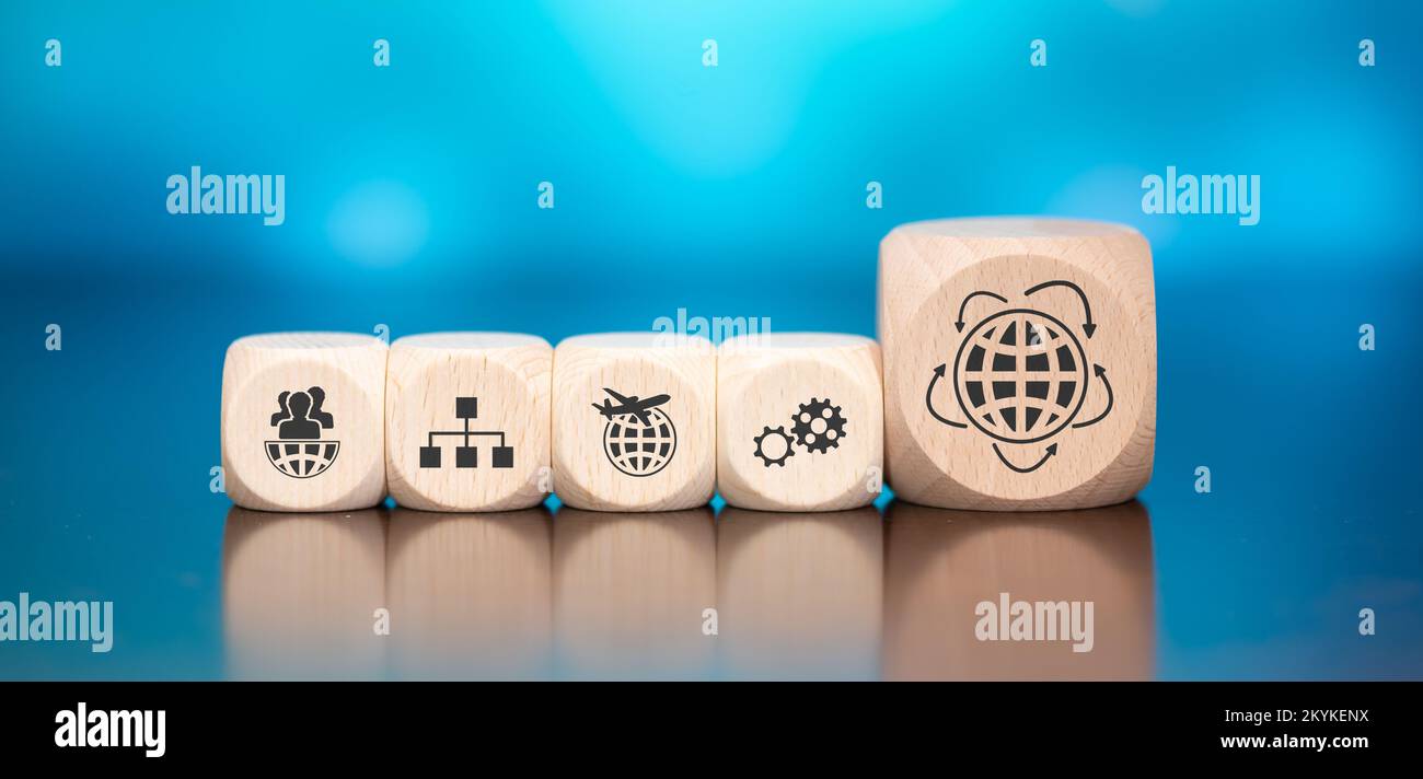 Wooden blocks with symbol of globalization concept on blue background ...