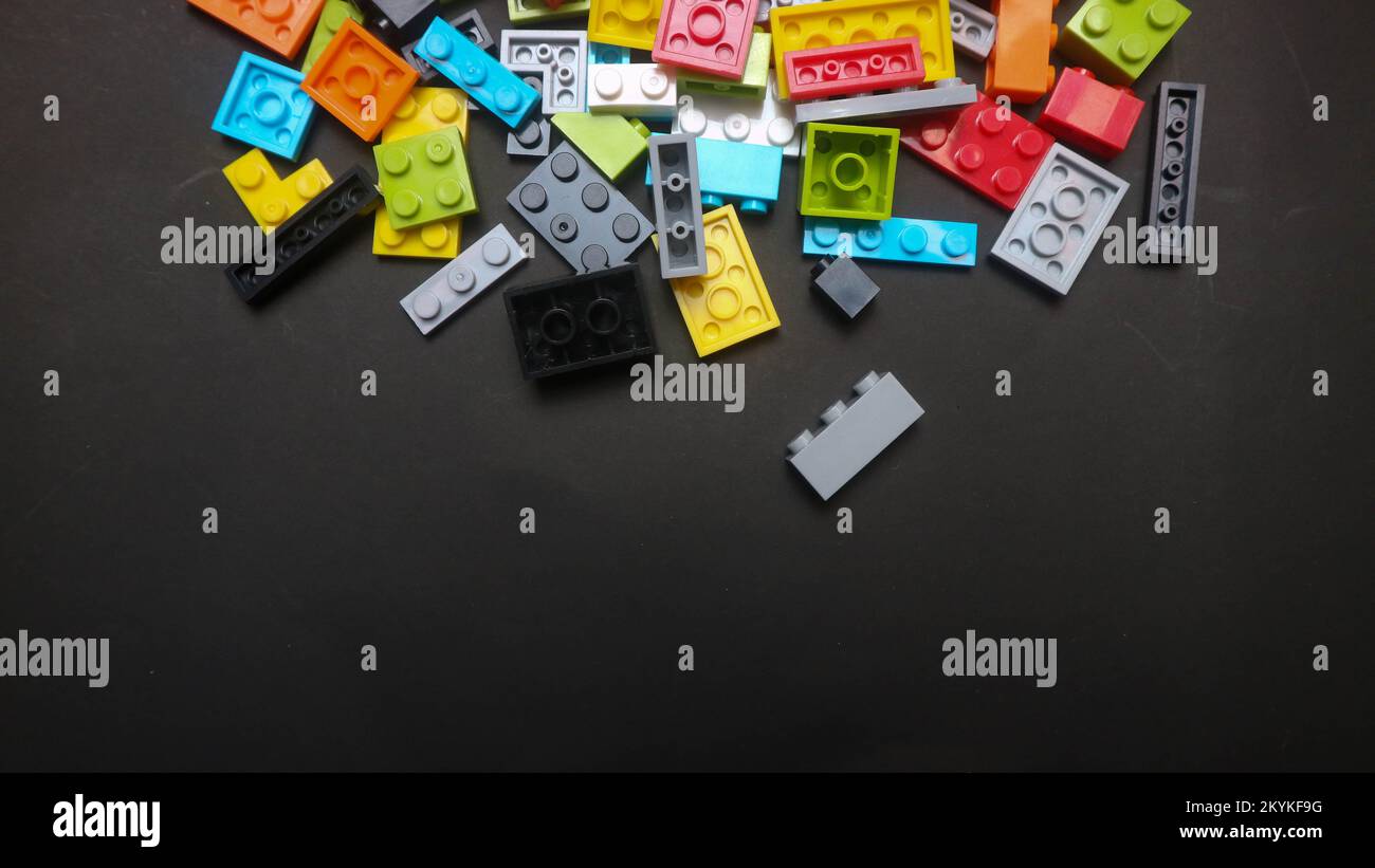 Plastic toy blocks on black background Stock Photo - Alamy