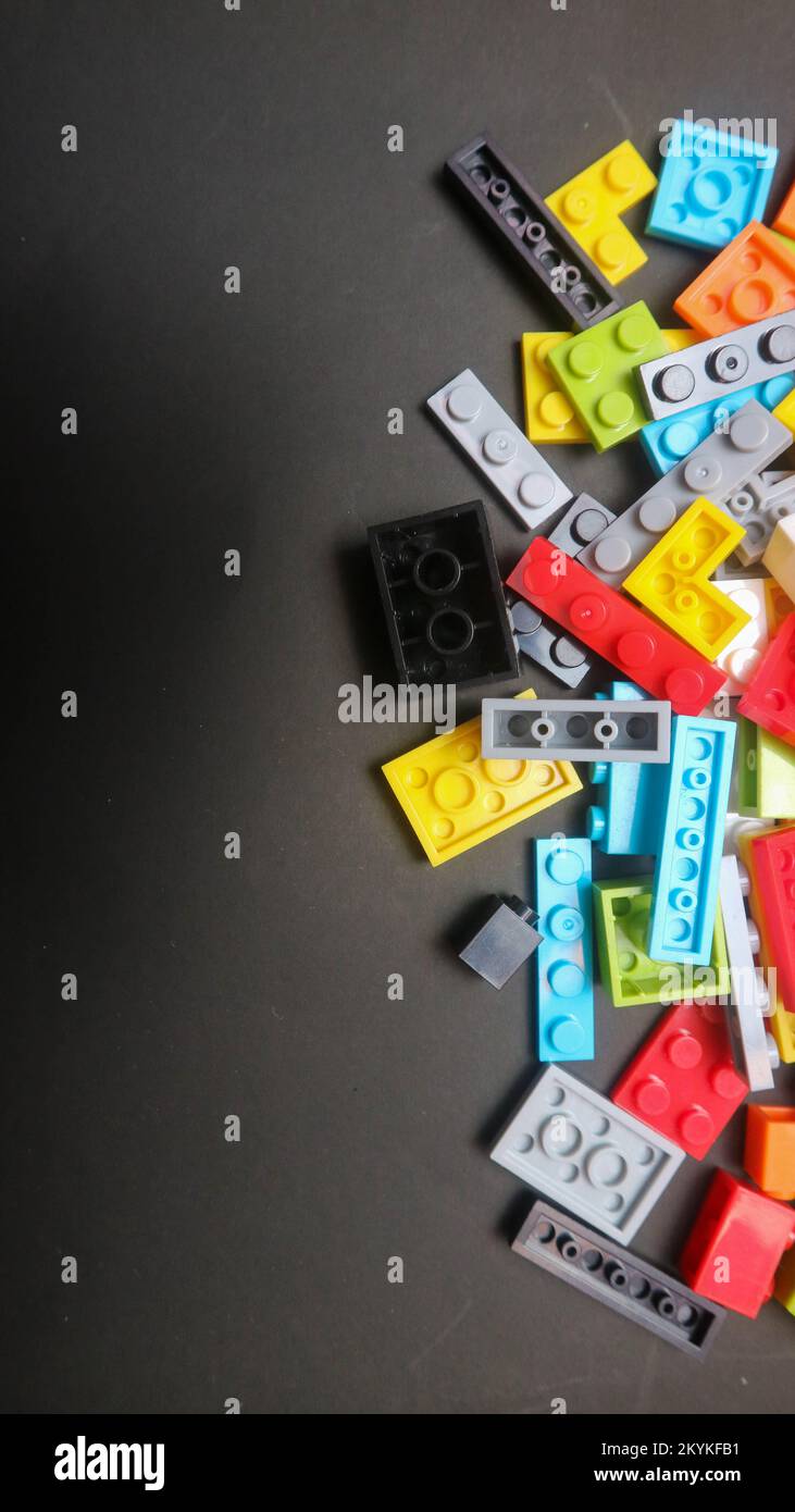 Plastic toy blocks on black background Stock Photo - Alamy