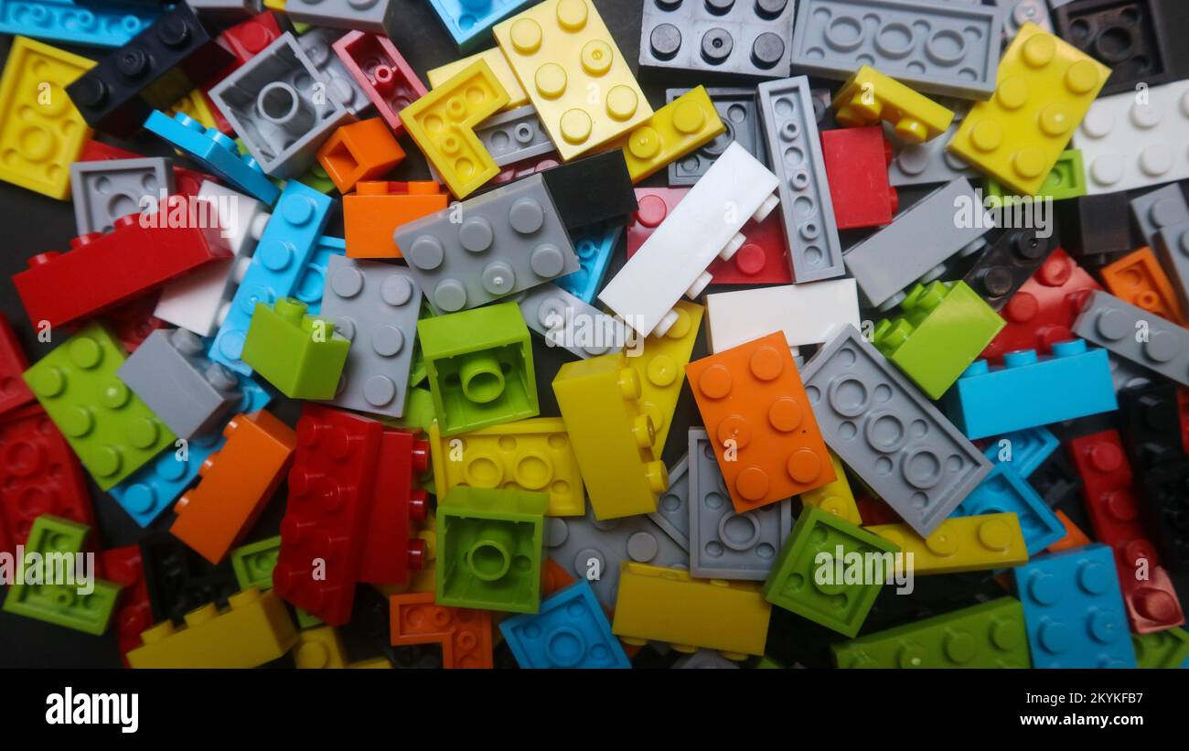 Plastic toy blocks on black background Stock Photo - Alamy