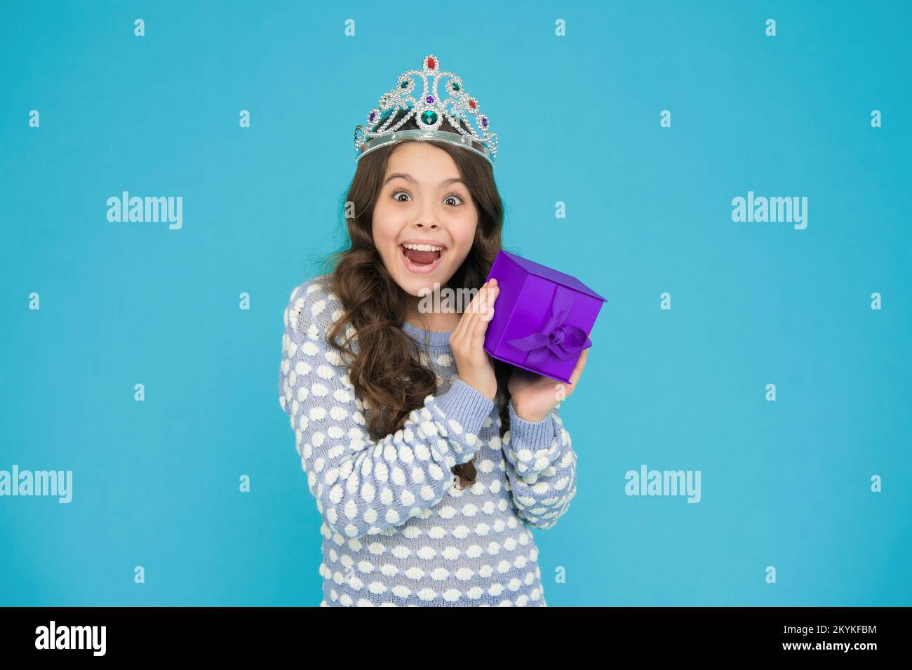 Excited child. Cute smiling little girl with gift box. Kid princess ...