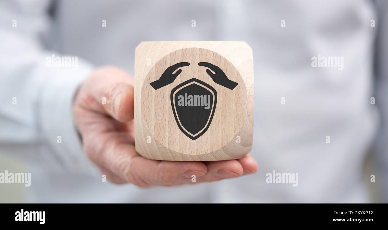 Hand holding a wooden cube with symbol of insurance concept Stock Photo ...
