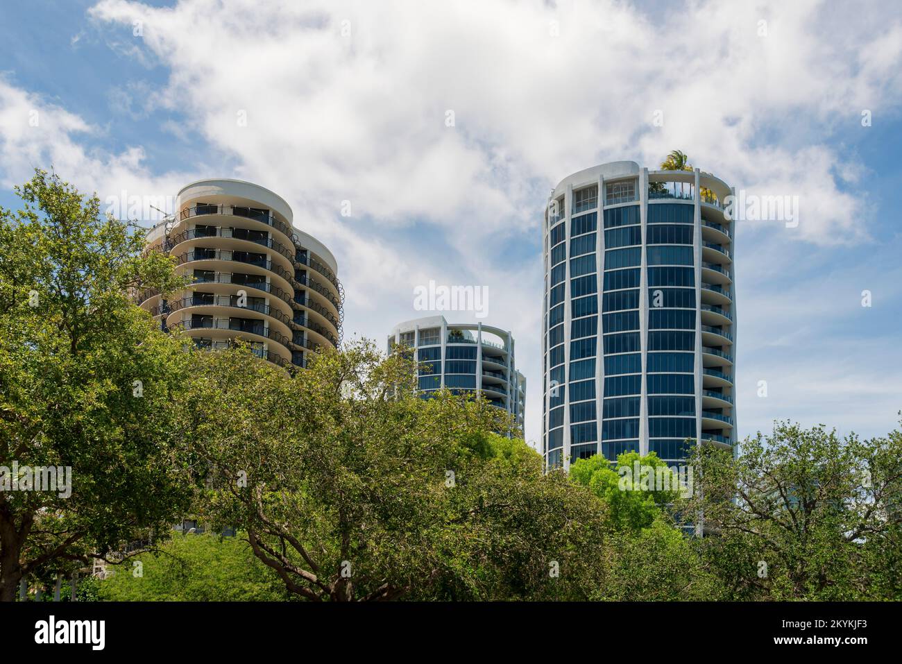 Views of circular high rise buildings against the clouds in the sky ...