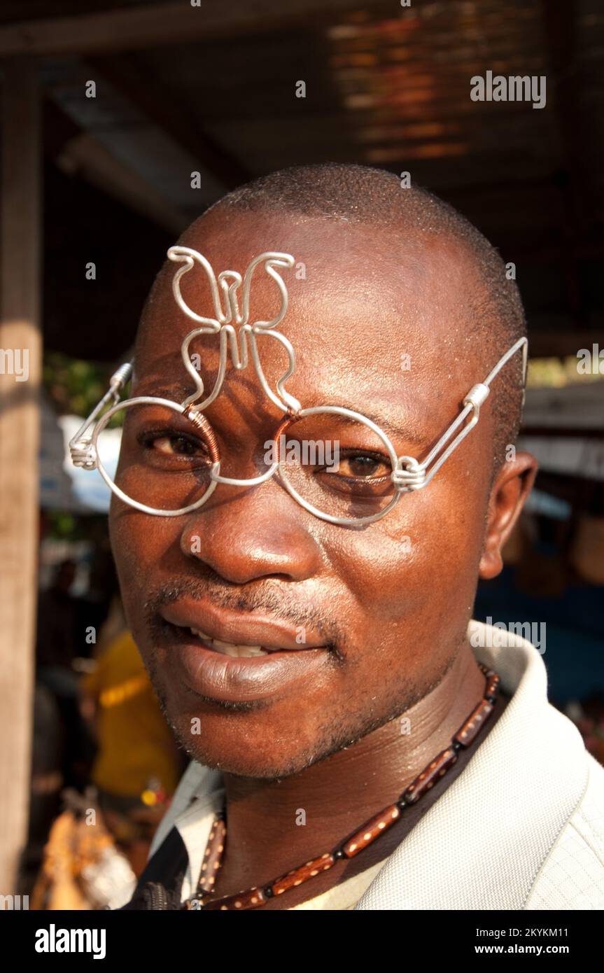 Salesman wearing metal wire glasses, Craft market, Kinshasa, Democratic ...