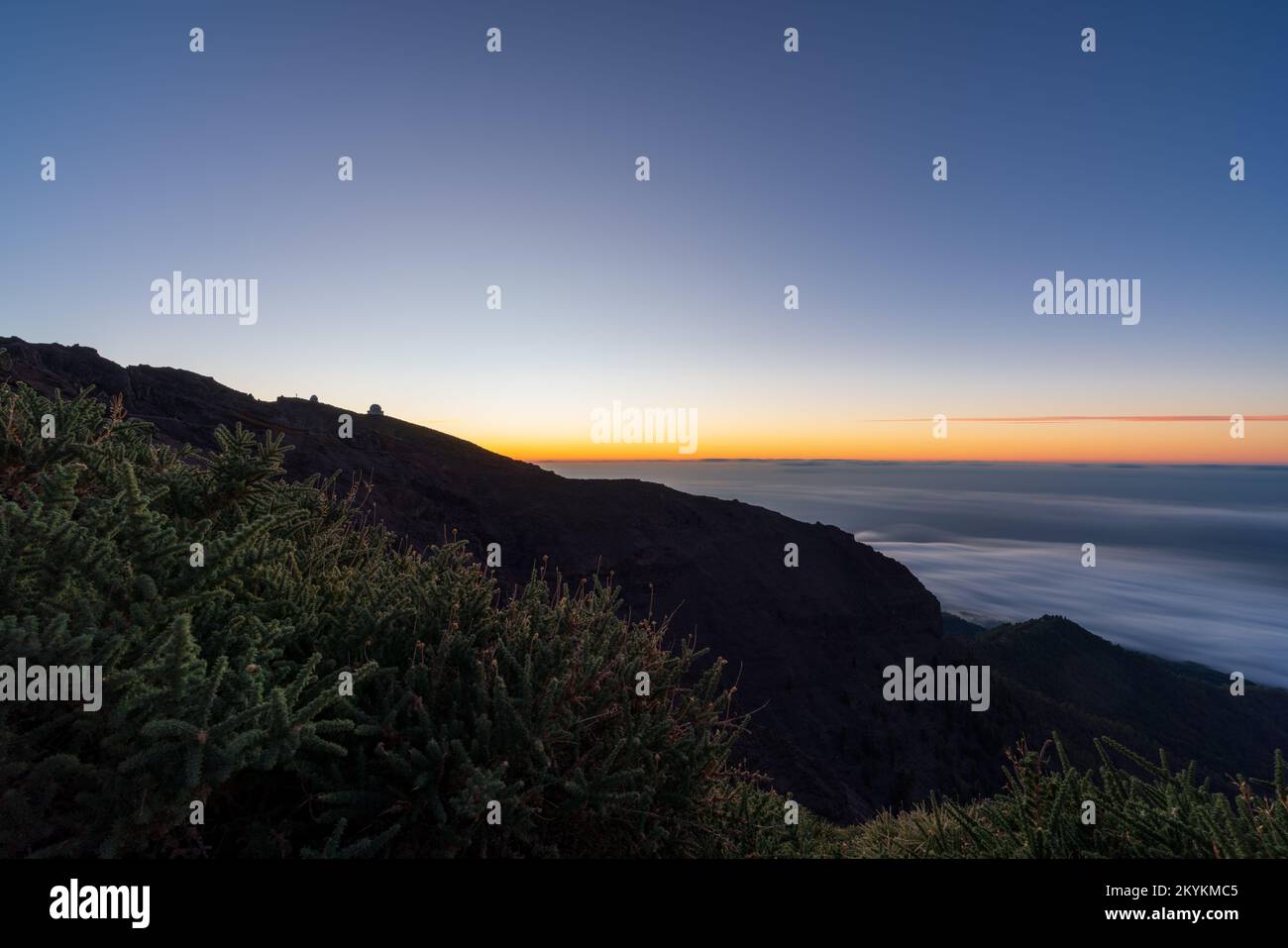 Sunset with sea of clouds and astronomical observatory Stock Photo - Alamy