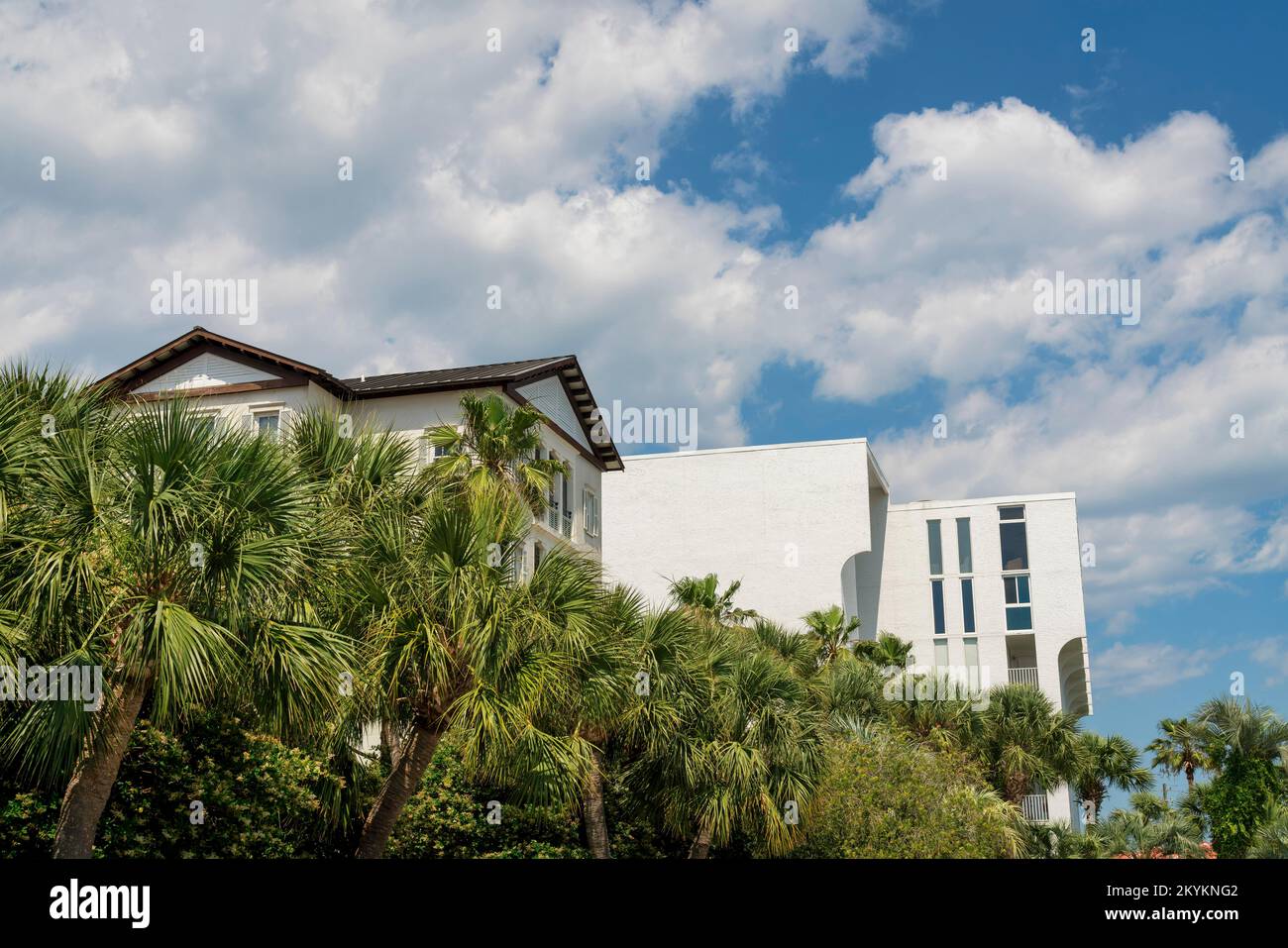 Destin, Florida- Trees at the front of house and flat buildings under a ...