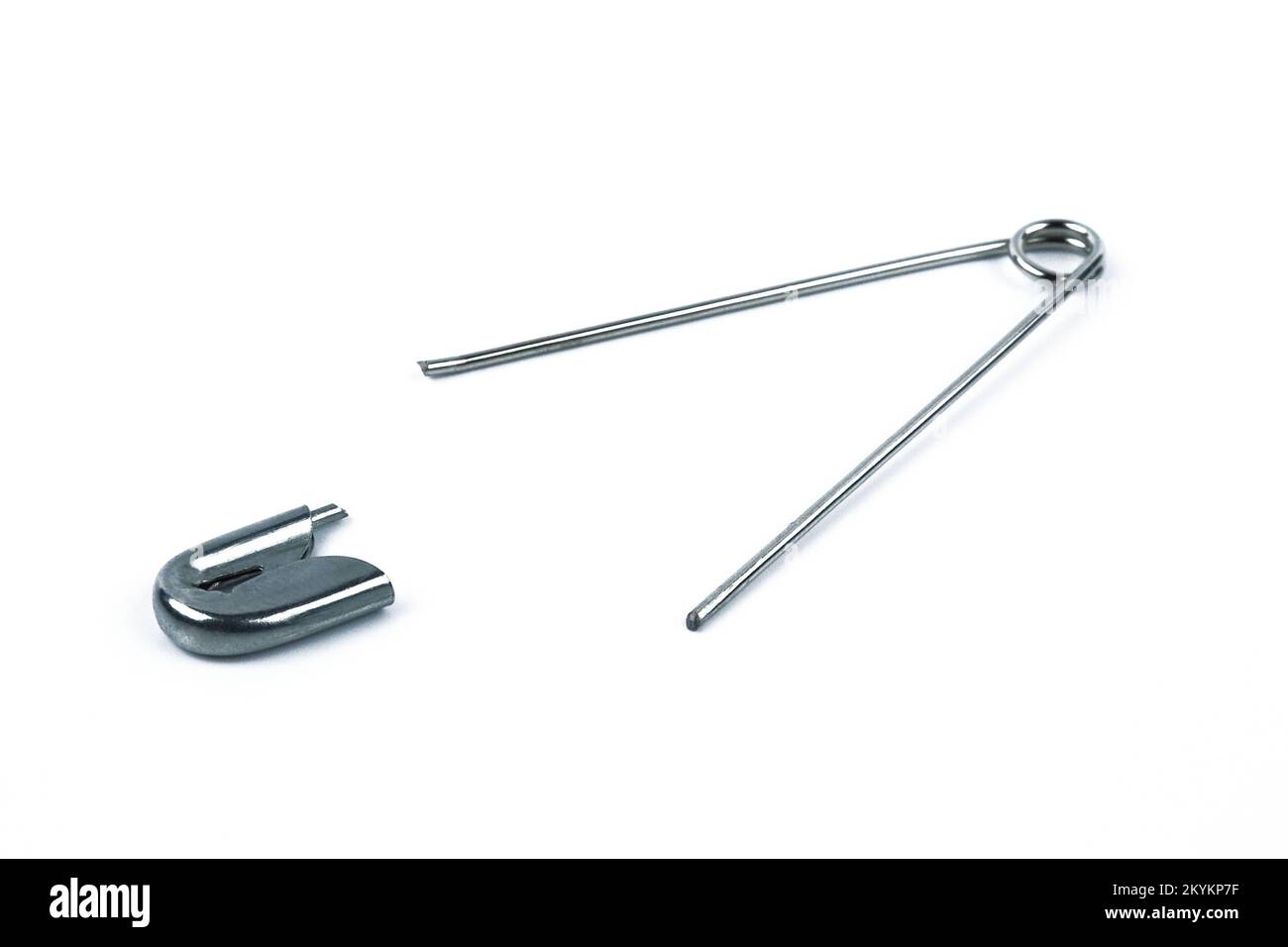 Broken safety pin isolated on white background Stock Photo - Alamy