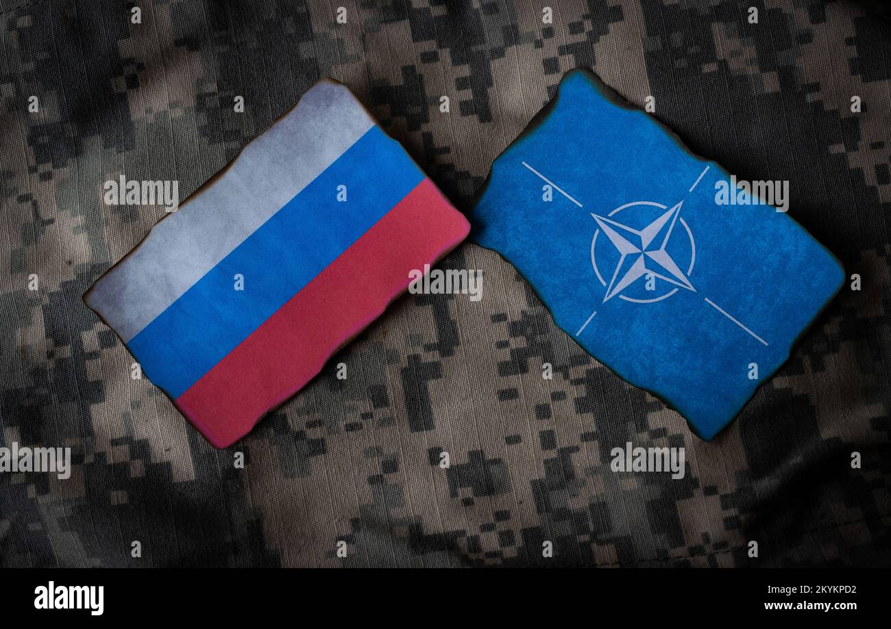 Russian and Nato flags crossed on camouflage background Stock Photo - Alamy