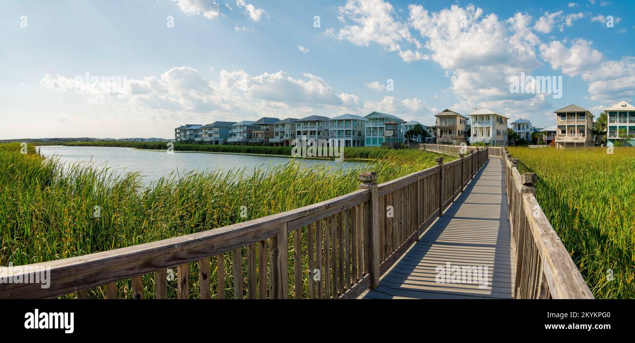 Boardwalk with wooden railings over the tall grasses in a lake near the ...