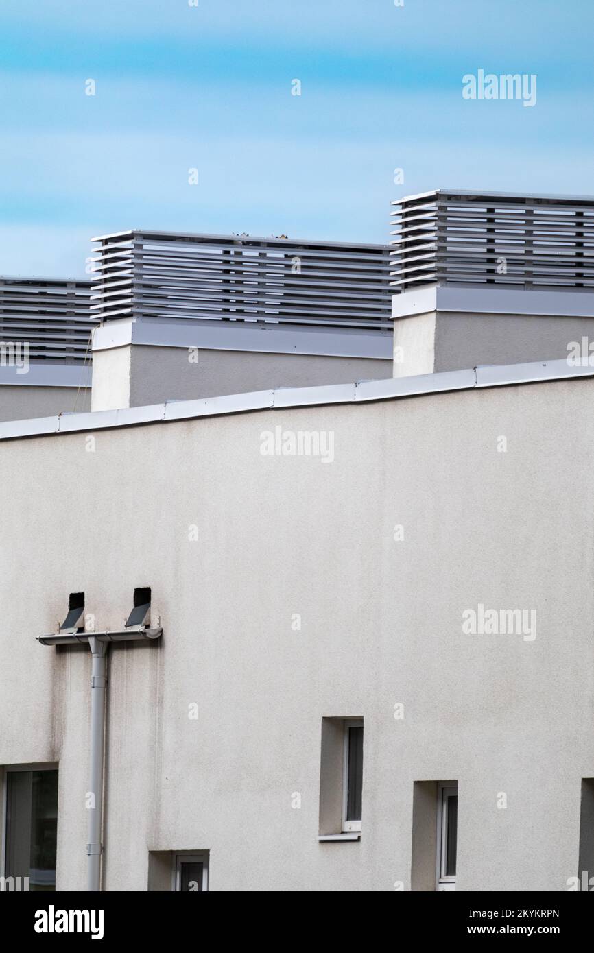 House outdoor roof ventilation units on white walls on sky background ...