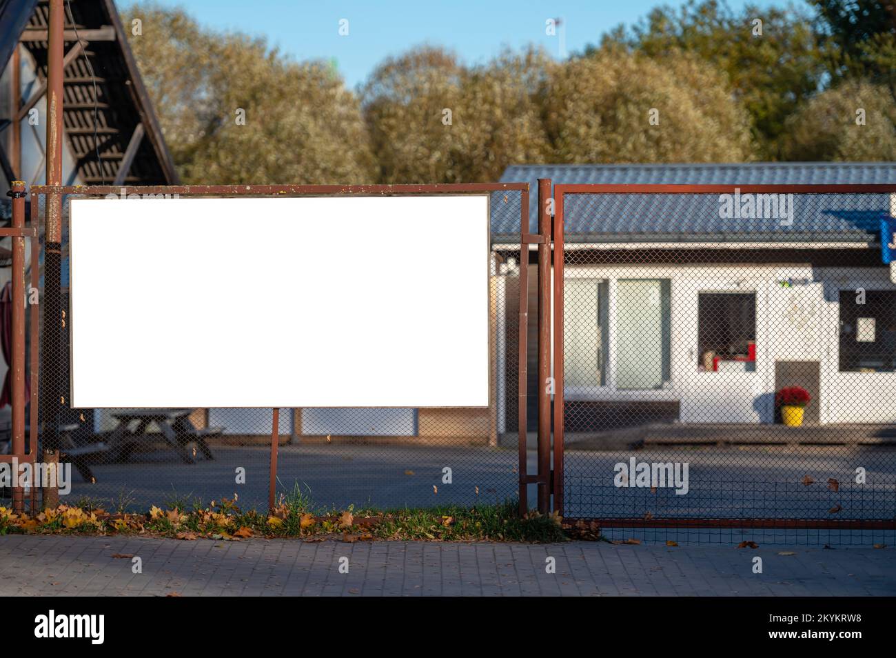 Blank white advert banner with mockup space on metal fence Stock Photo ...