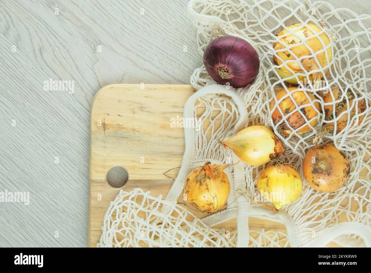 Various farm organic onions on a white wooden background. Zero waste ...