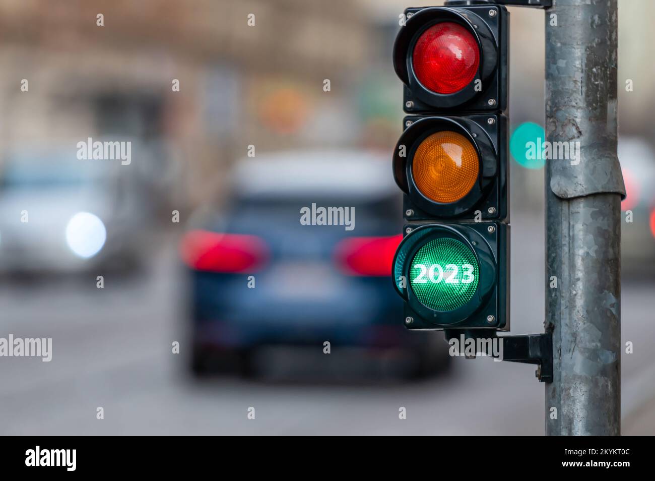 A city crossing with a semaphore. Green light with text 2023 in ...