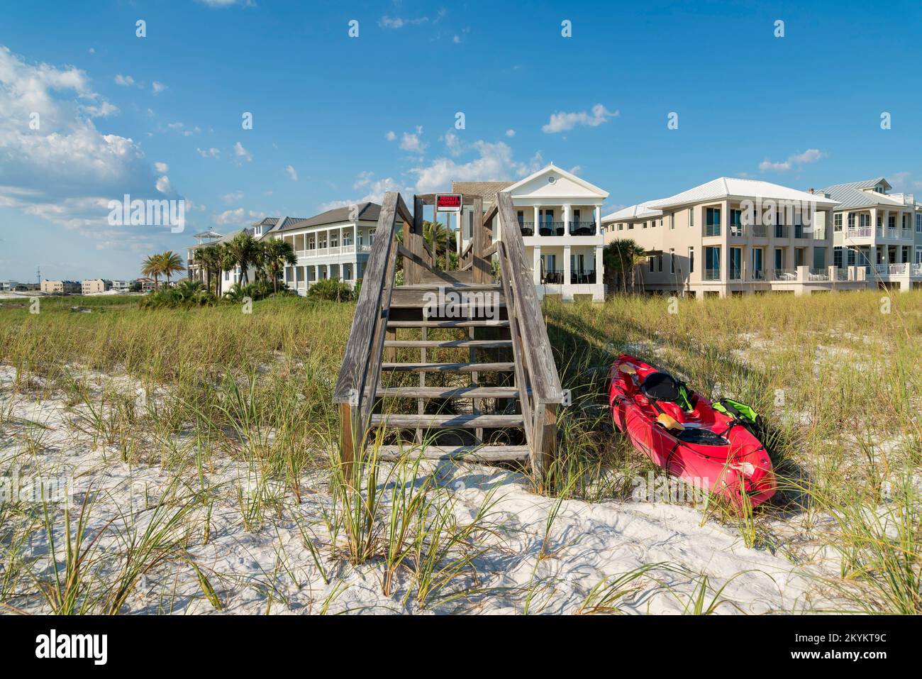 Destin, Florida- Red kayak boat beside the stairs of a footbridge over ...