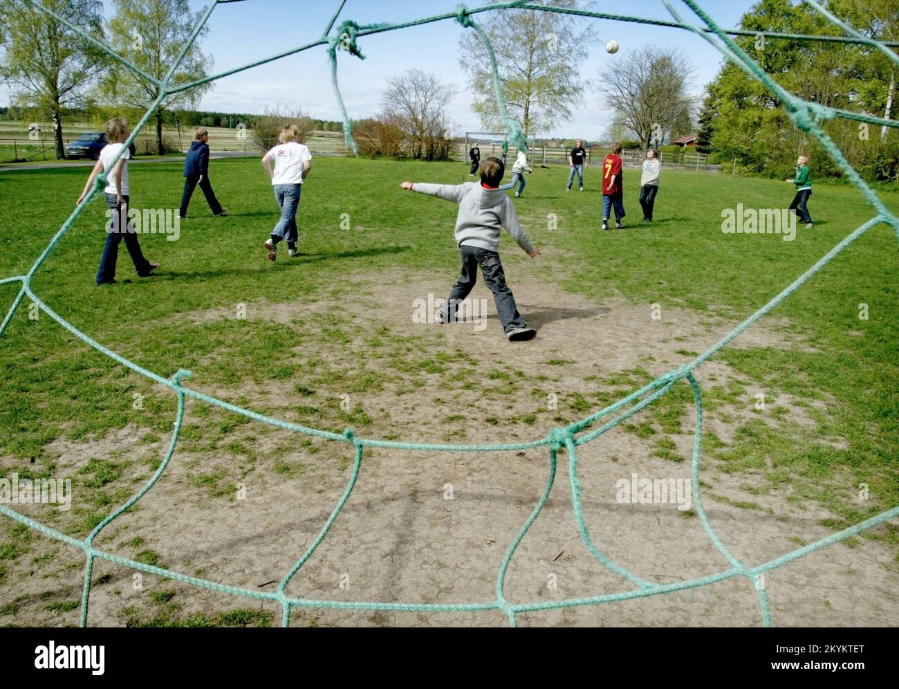 School children playing football during a break at a school Stock Photo ...