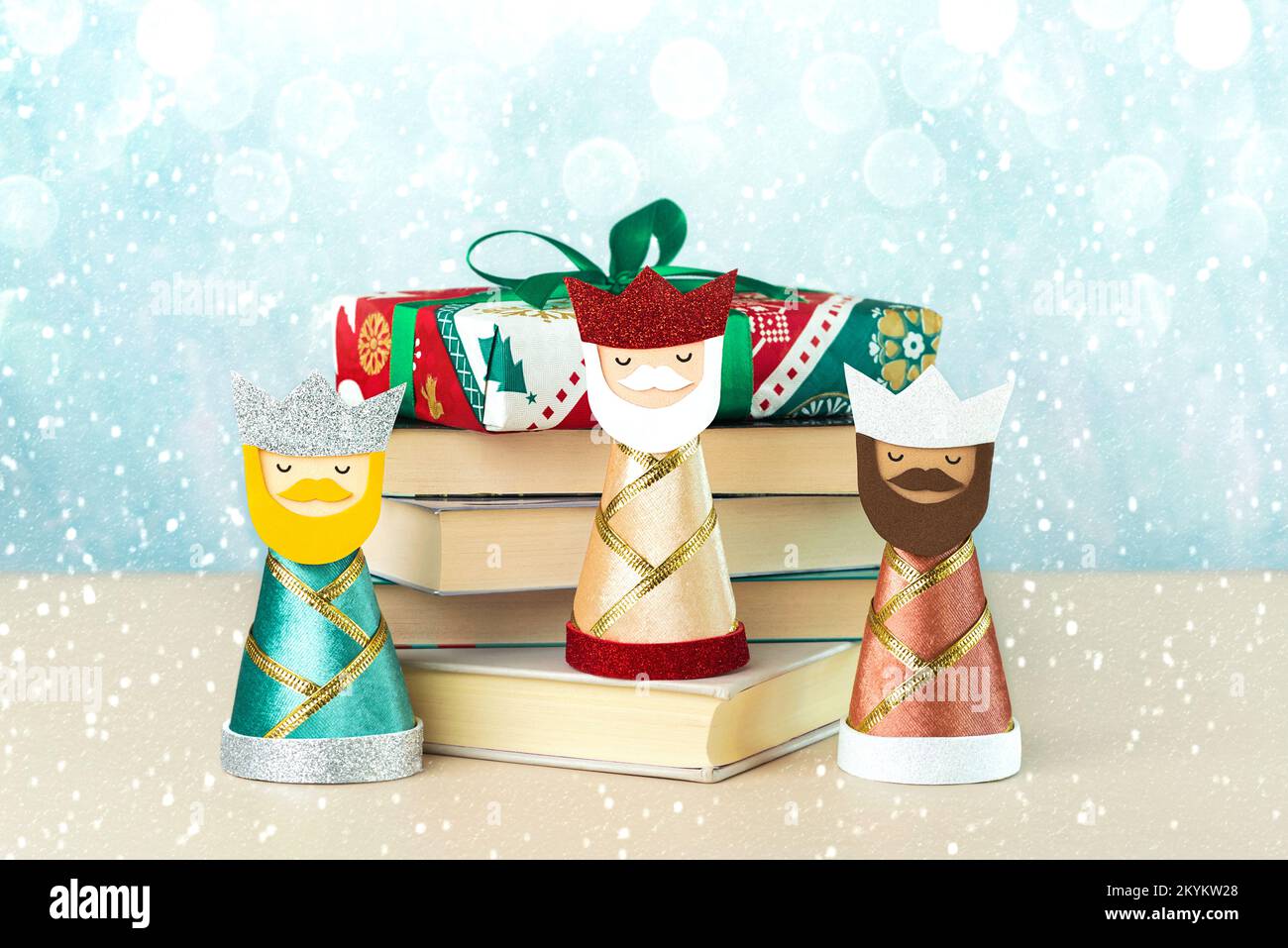 The Three Wise Men With Books Snowflakes And Christmas Lights Over Blue