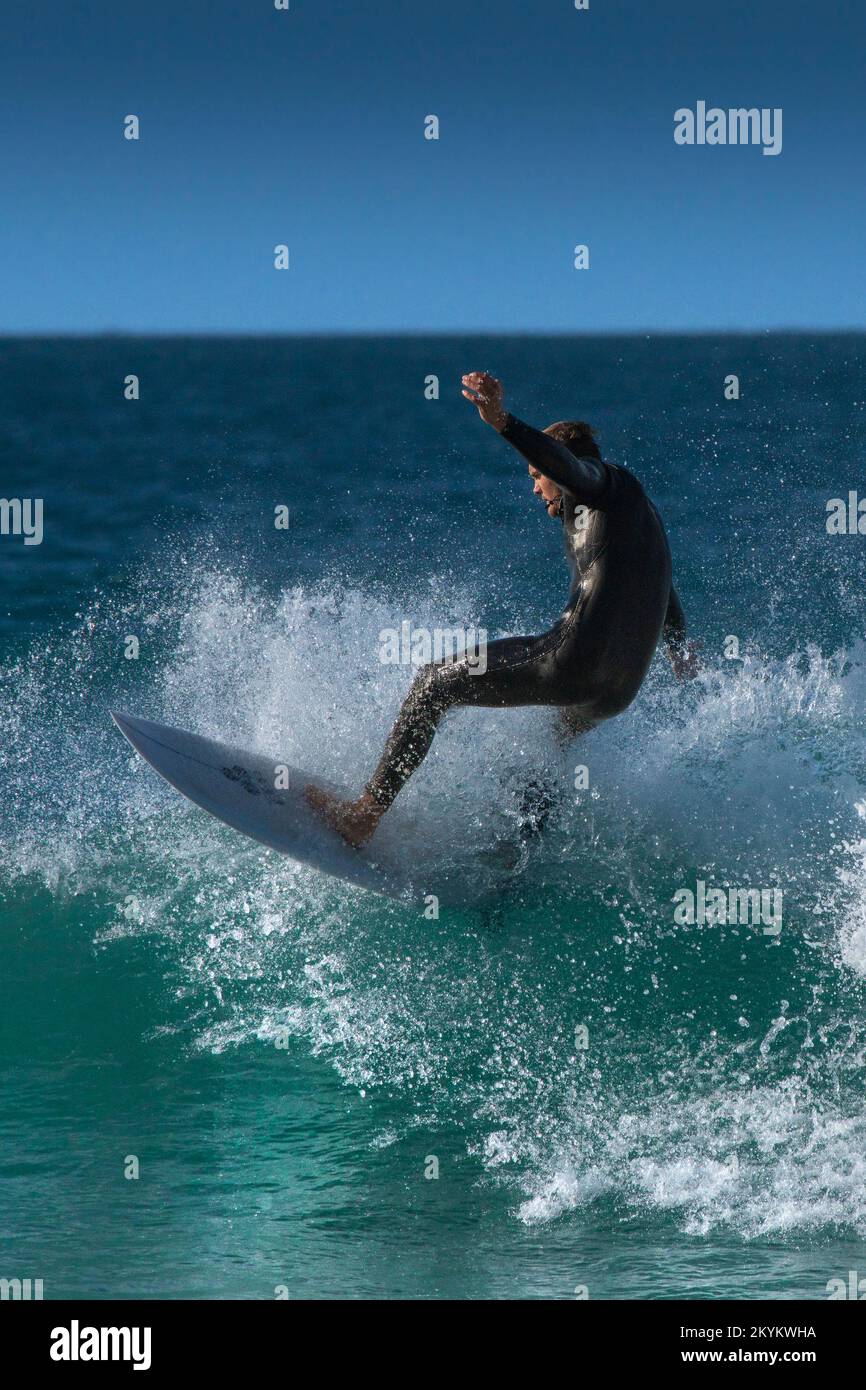 Spectaular surfing action as a male surfer rides a wave at Fistral in ...