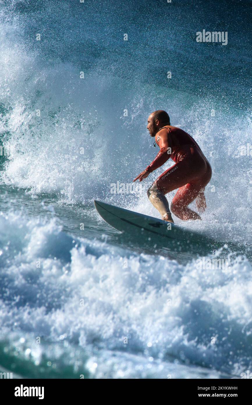 Spectaular surfing action as a male surfer rides a wave at Fistral in ...