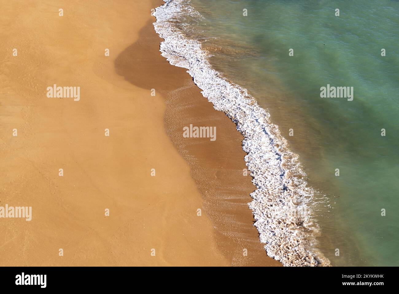 Aerial view of sandy beach and ocean with waves. Water Sand texture ...