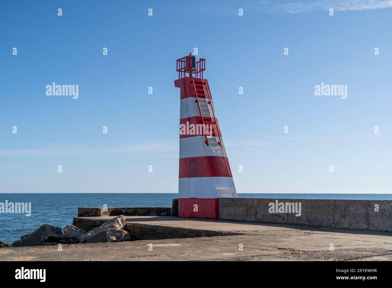 Red and white Lighthouse on pier Stock Photo - Alamy