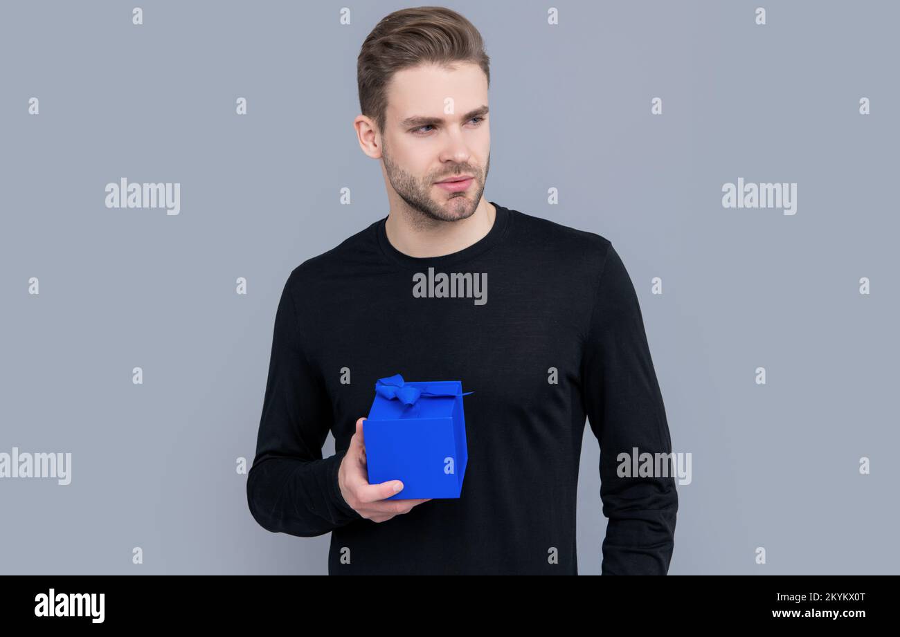 man hold present isolated on grey background. man with present box in ...