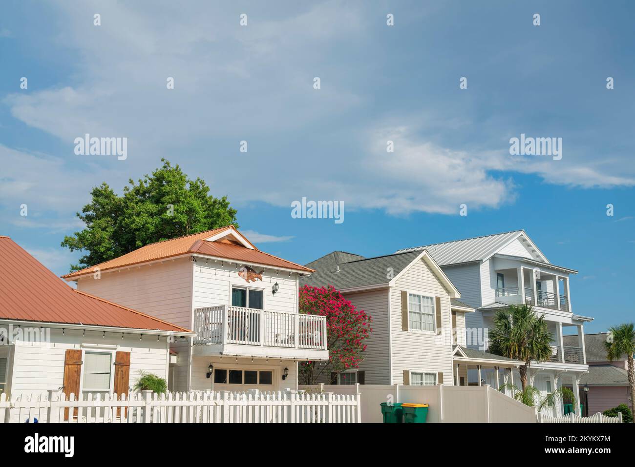 Facade of fenced suburban houses with wood wall sidings in Destin ...