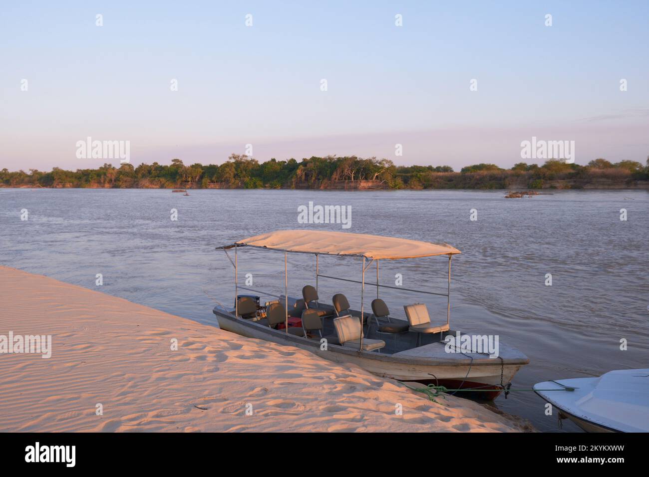 A tourists boat moored on the bank of The Rufiji river Stock Photo - Alamy