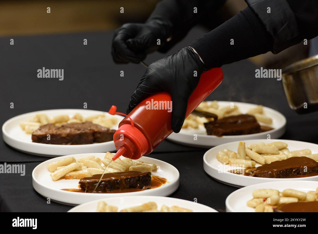 chef is serving pasticada with gnocchi, beef stew in a sauce. Croatian ...