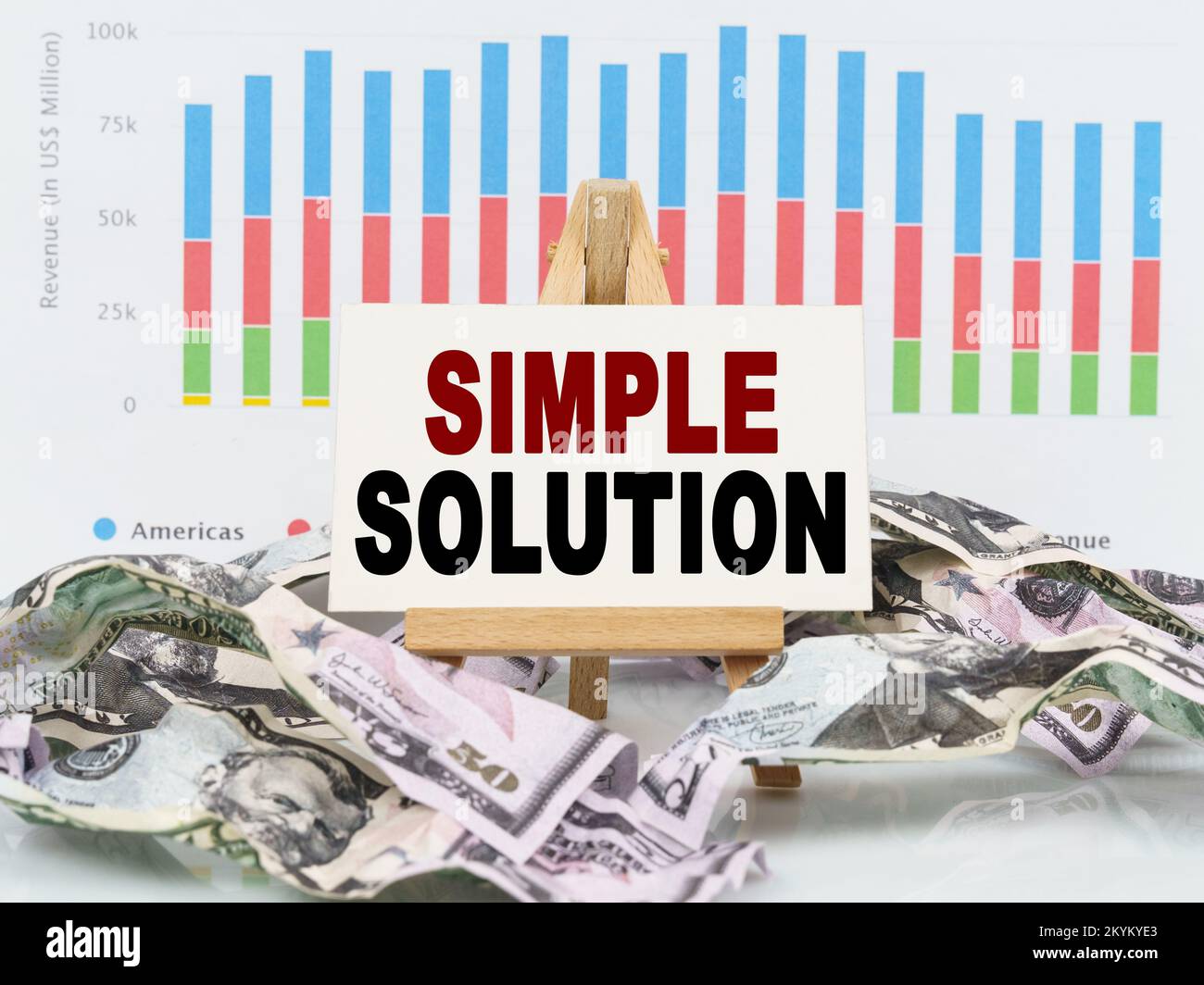 Business and finance concept. Among financial charts and money is a ...