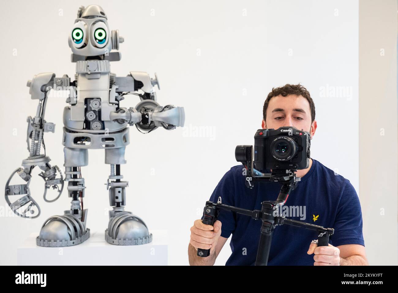 London, UK. 1 December 2022. A staff member makes a video at the ...