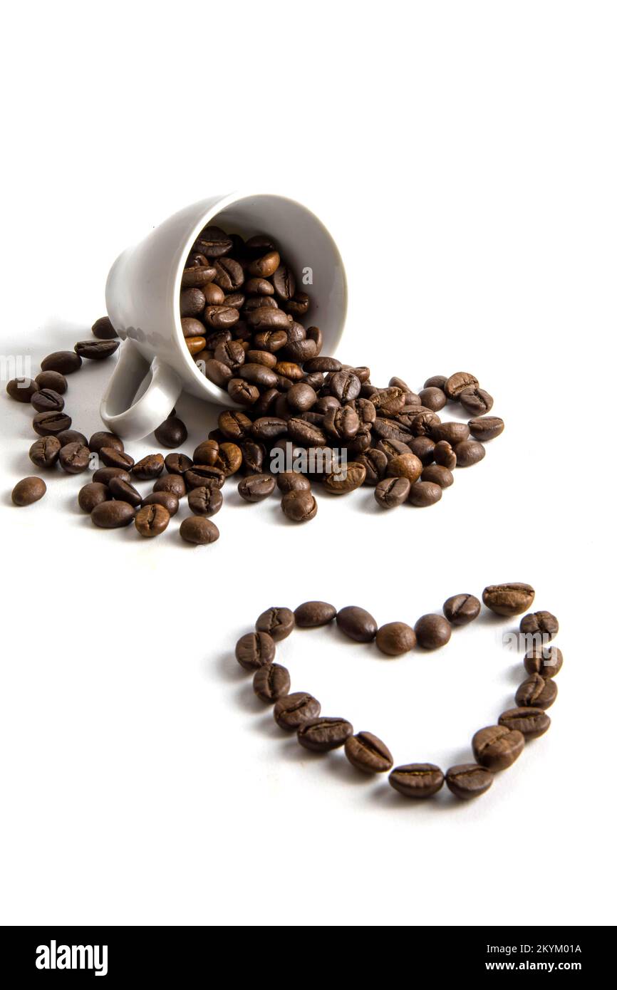Spilled coffee beans from a cup with a heart pattern Stock Photo - Alamy