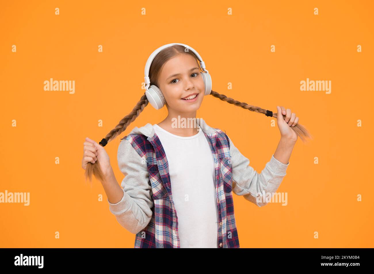 Headphones with wireless technology. Small child listening to music ...