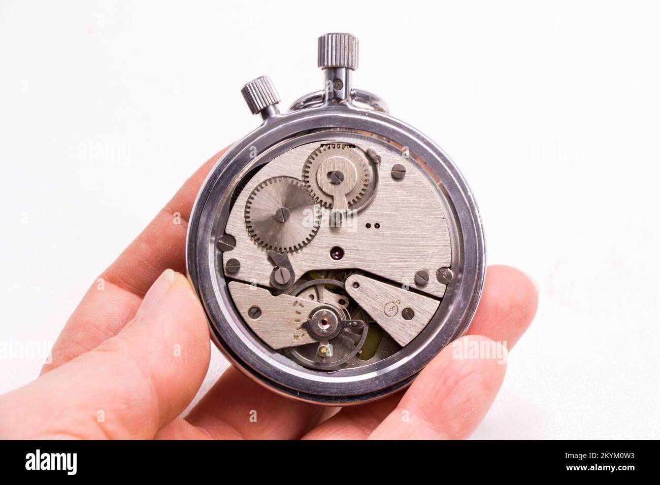 Old antiquary timer clock and humans hand, white background Stock Photo ...
