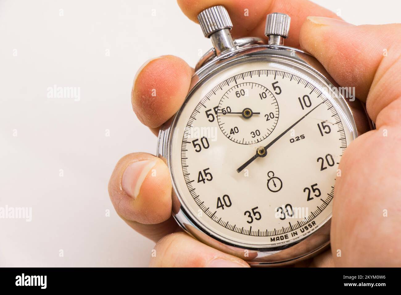 Old antiquary timer clock and humans hand, white background Stock Photo ...