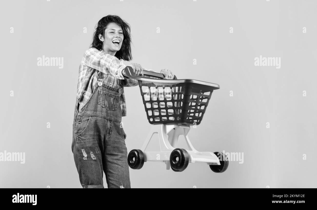 happy woman carry shopping cart. shopper girl have fun. marketing ...