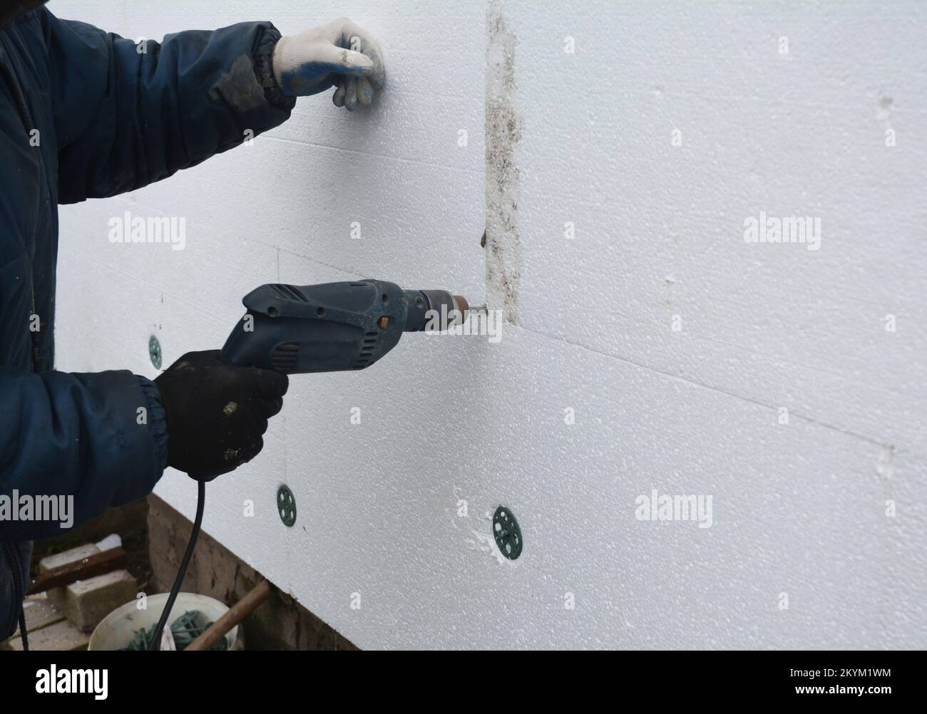 Builder contractor installing thermal exterior wall insulation ... Builder contractor installing thermal exterior wall insulation ...