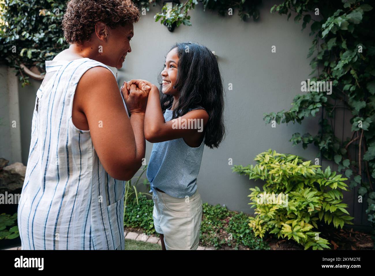 Girl and granny having fun together. Kid and grandmother looking at ...
