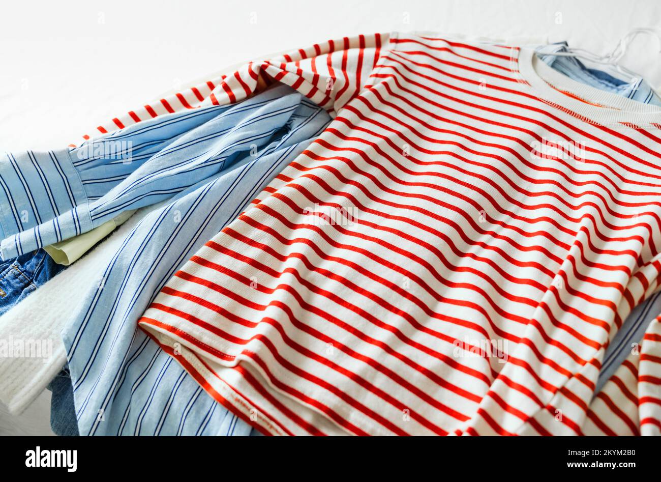 Pile of clothes on bed Stock Photo - Alamy