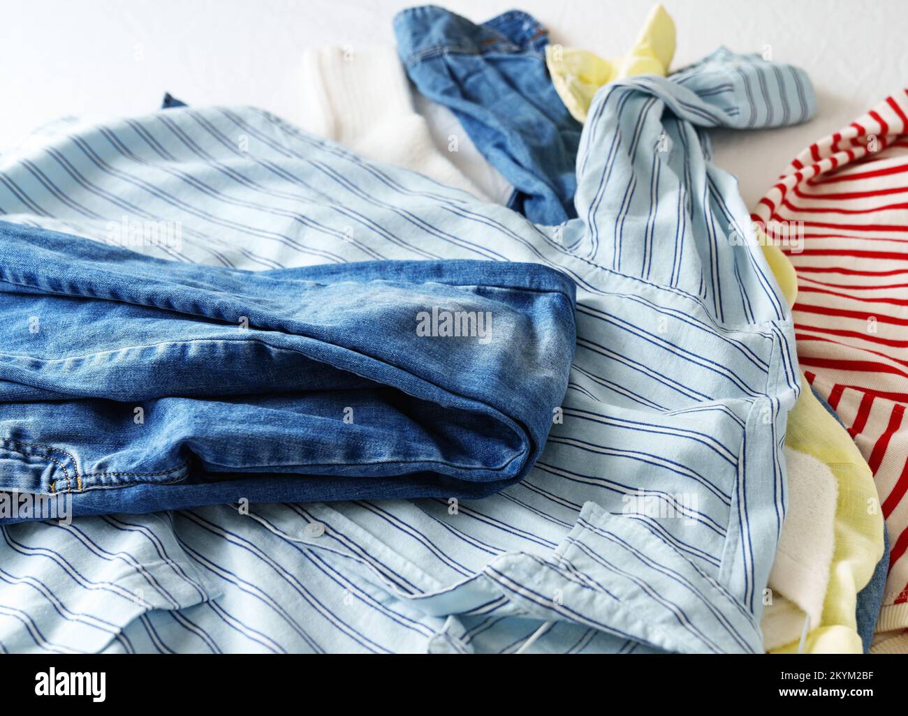 Pile of clothes on bed Stock Photo - Alamy