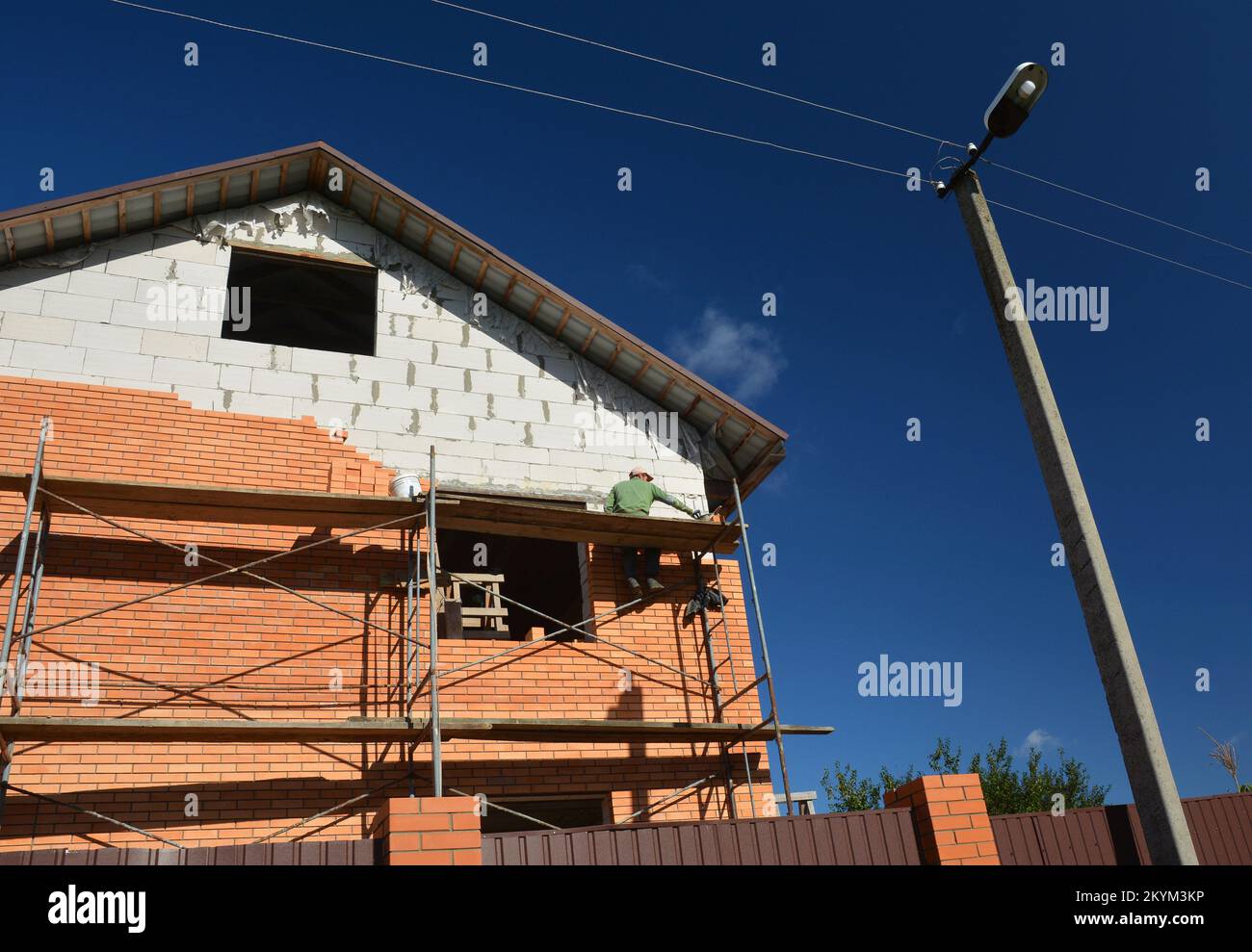 House under construction with bricklaying facing bricks on the aerated ...